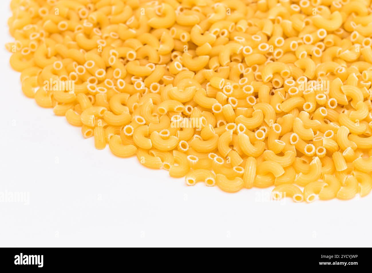 A Heap of Uncooked Chifferi Rigati Pasta on White Background. Fat and ...