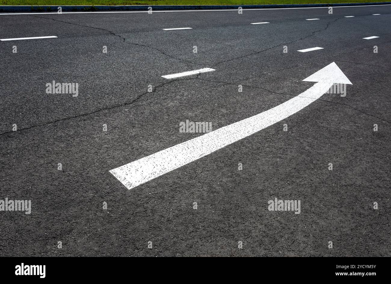 Traffic sign white arrow on asphalt road Stock Photo - Alamy