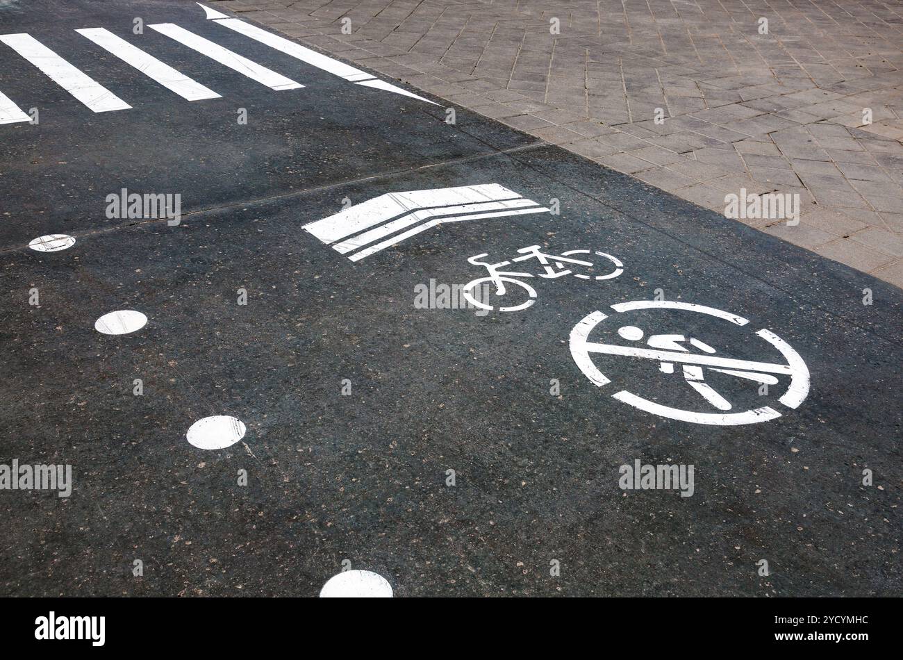 Bike lane with road symbols painting on asphalt Stock Photo - Alamy