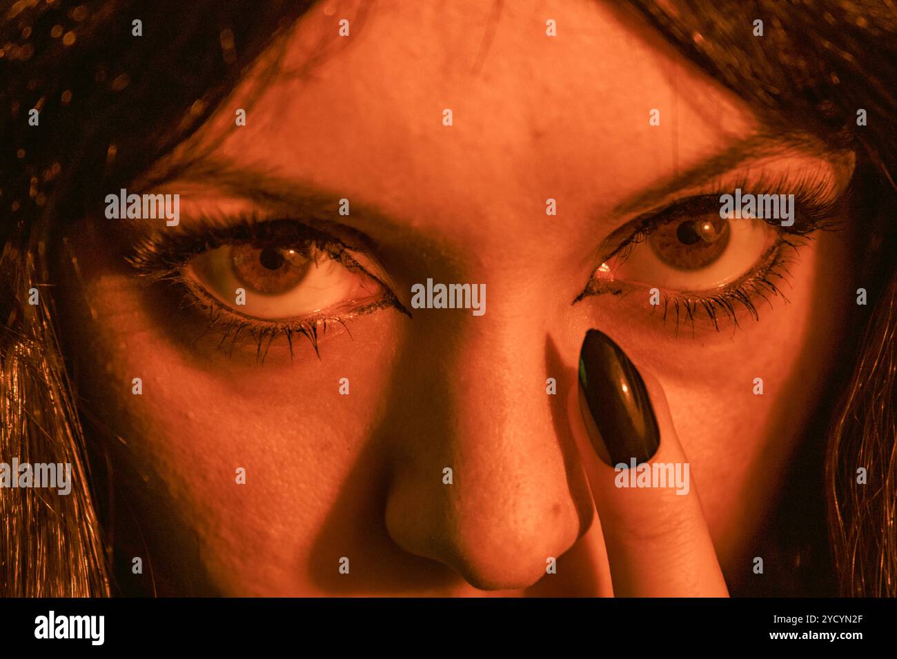 A close-up shot of a witch's face as she raises her long, sharp black ...