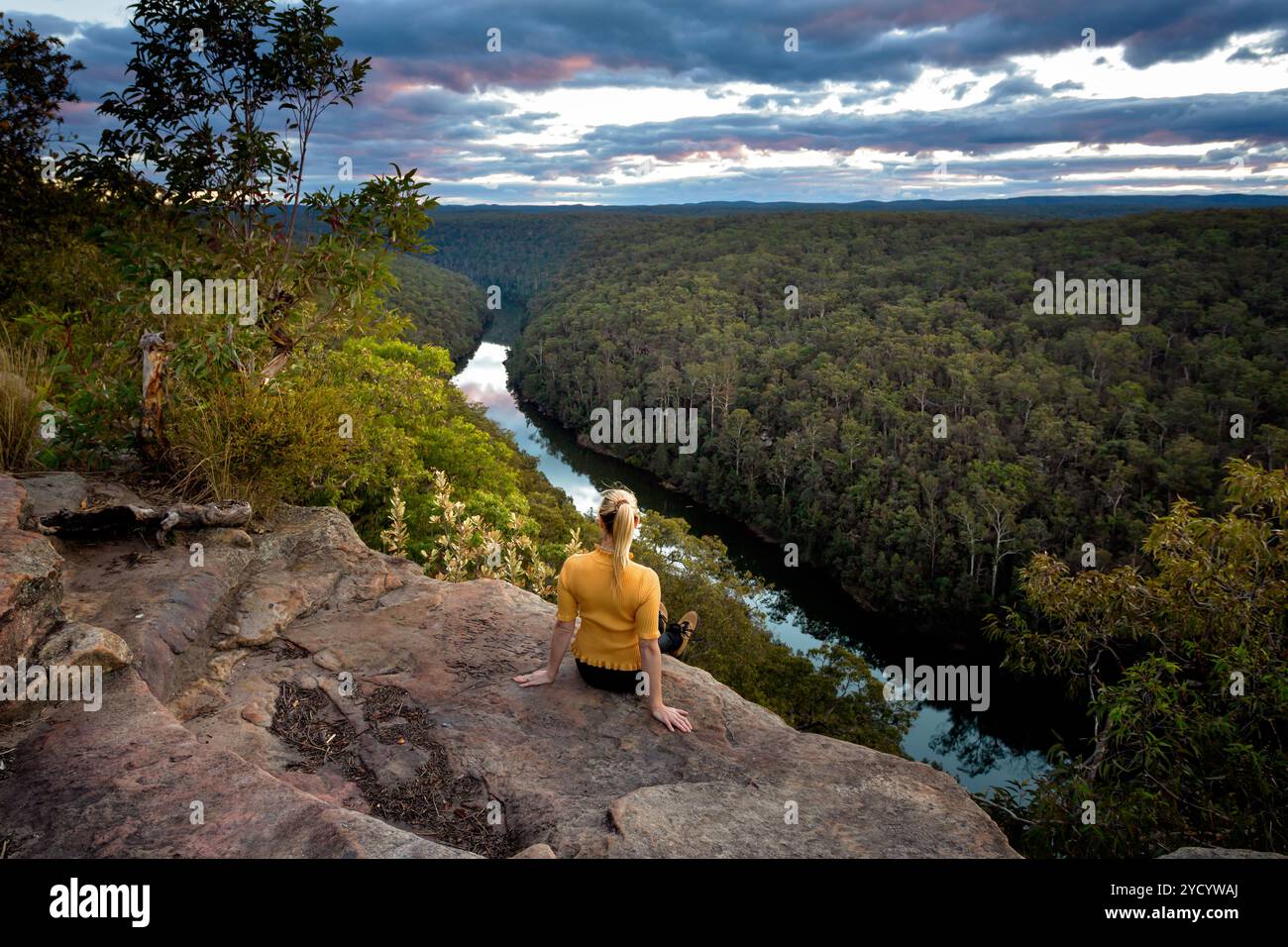 Female enjoying river views from cliff top Stock Photo - Alamy
