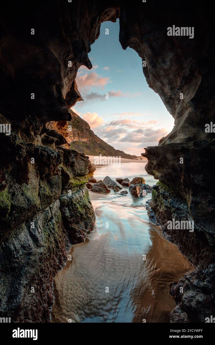 Nature's window - sunrise beach cave Stock Photo - Alamy