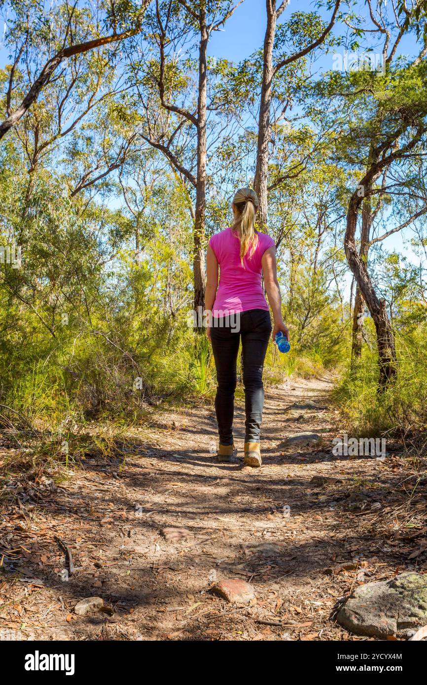 Female walking along a bush track among nature Stock Photo - Alamy