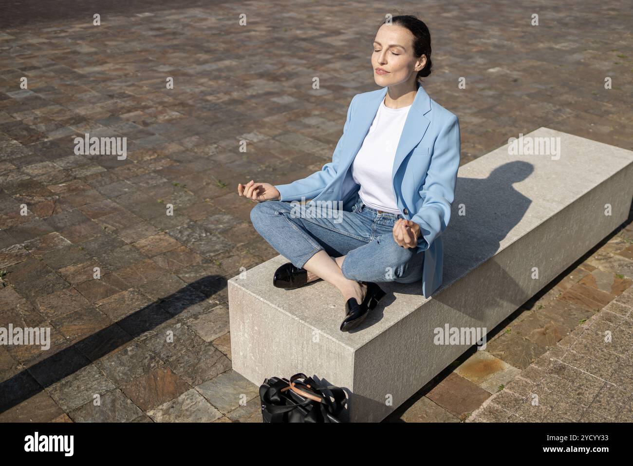 Young professional woman is practicing mindfulness meditation to ...
