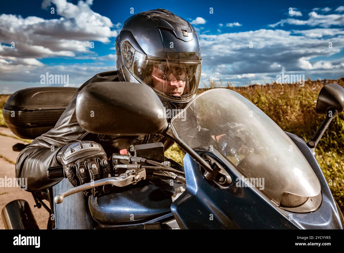 Biker racing on the road Stock Photo - Alamy