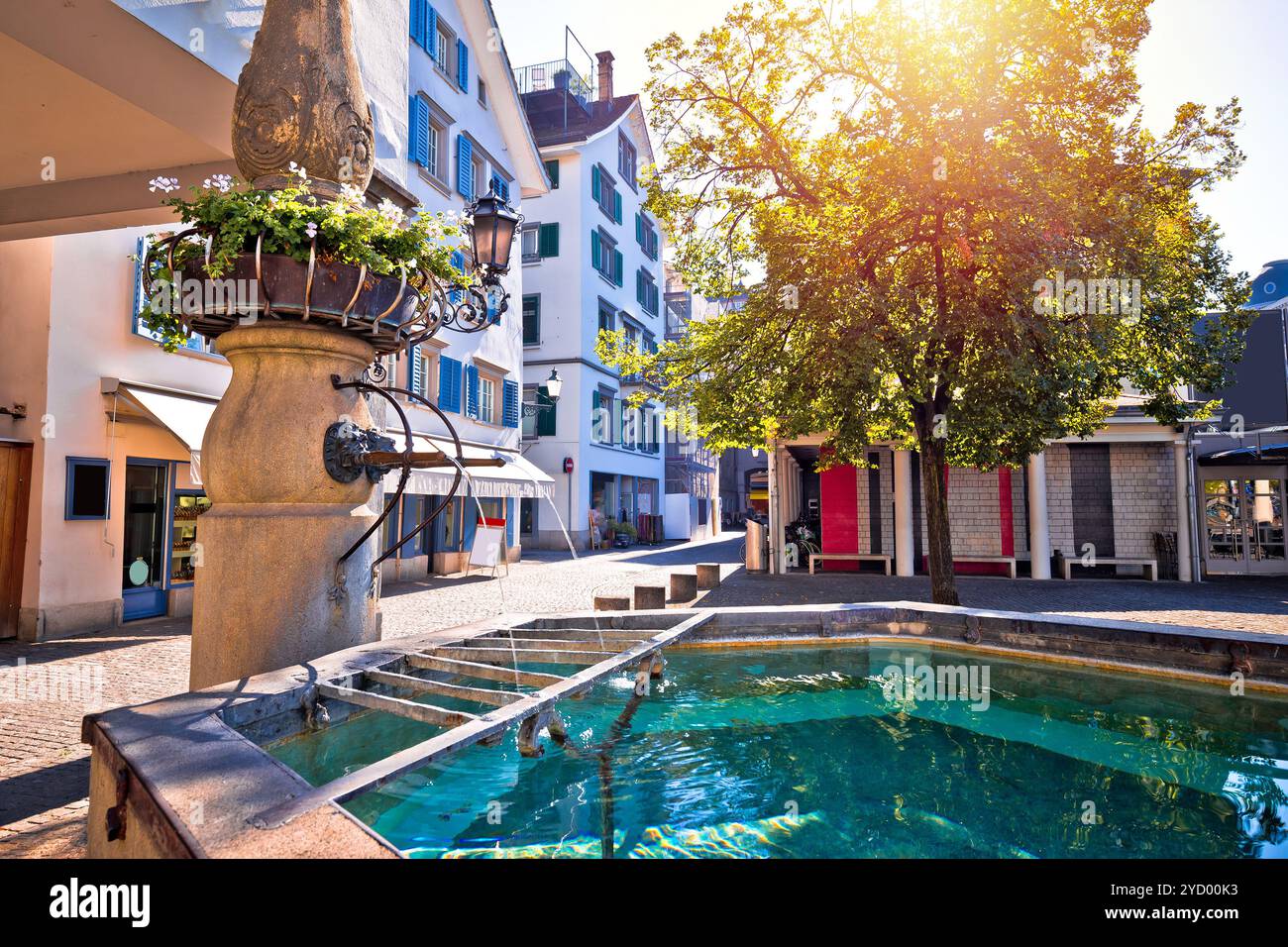 Zurich fountain and street view with sun haze Stock Photo - Alamy