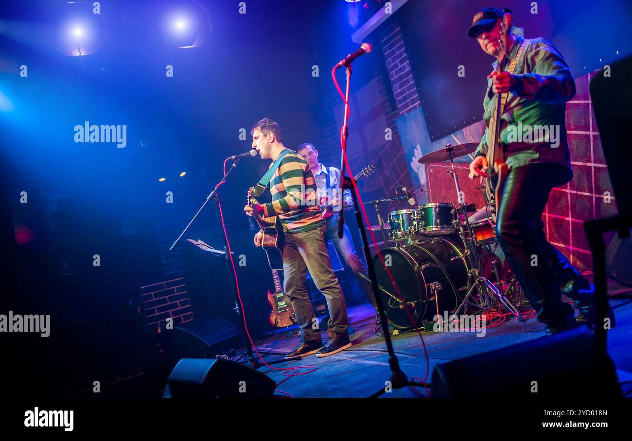 Band performs on stage, rock music concert in a nightclub. Authentic ...