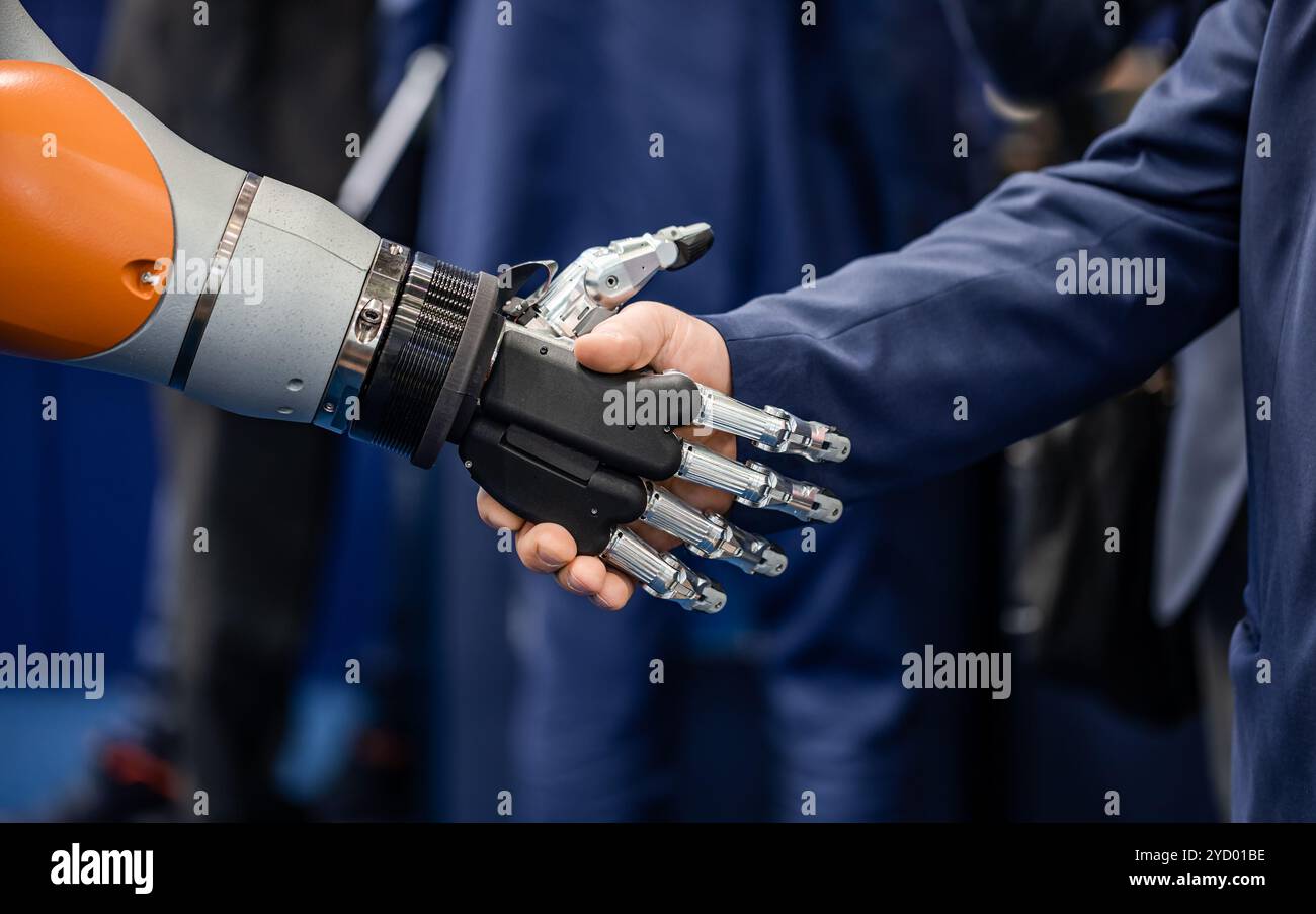 Hand of a businessman shaking hands with a Android robot Stock Photo ...