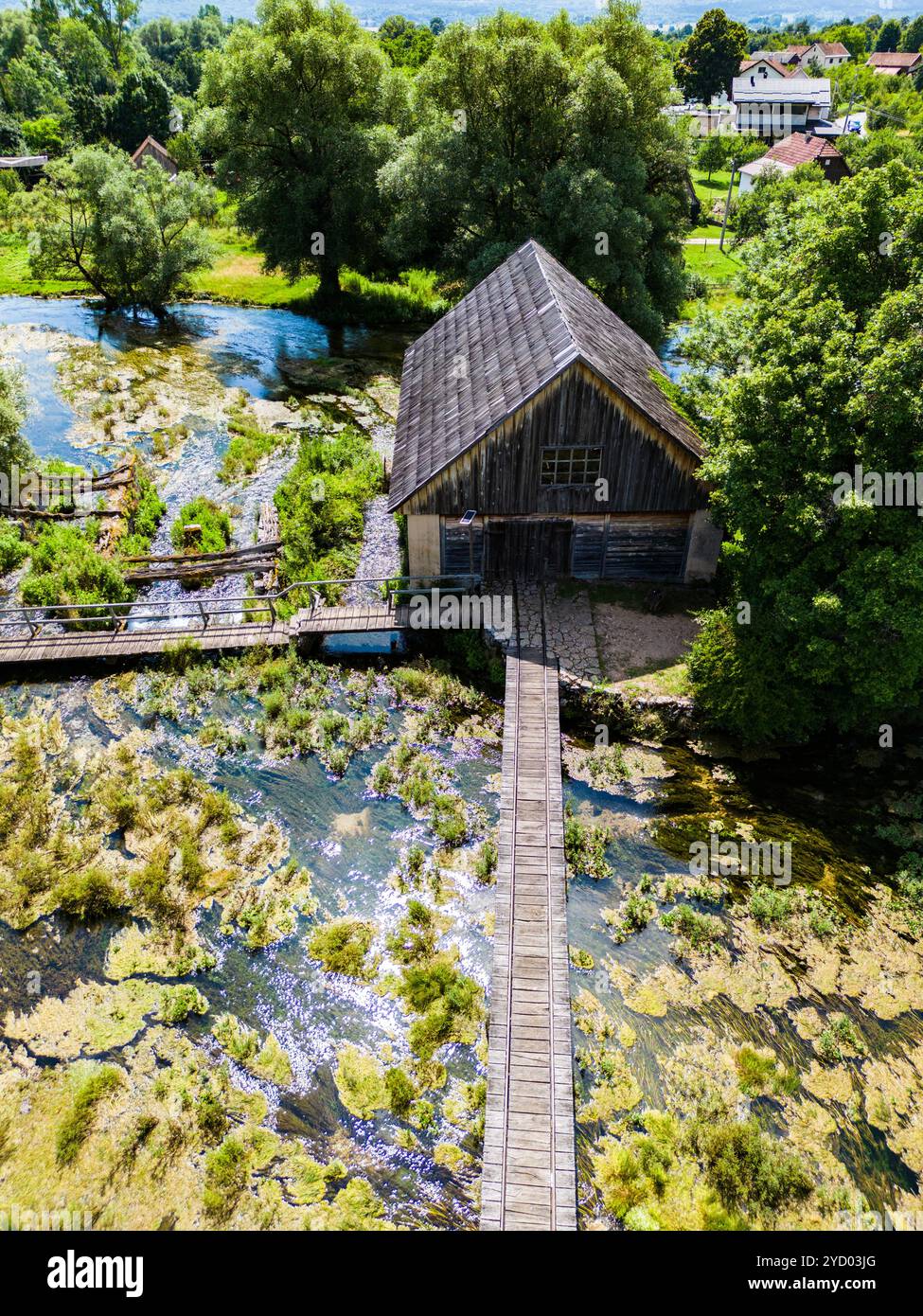 Drone view of wooden mill houses of Majerovo Vrilo located on Gacka ...