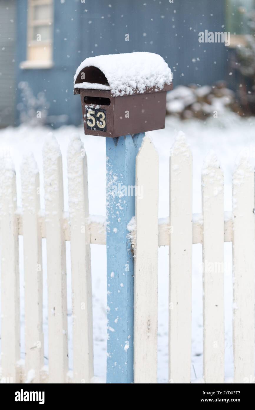 Mailbox and picket fence with falling snow in winter Stock Photo - Alamy