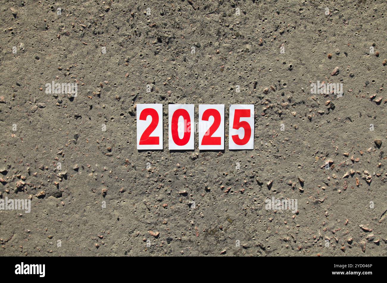 Numbers of 2025 year. Paper square numbers on the grey concrete ...