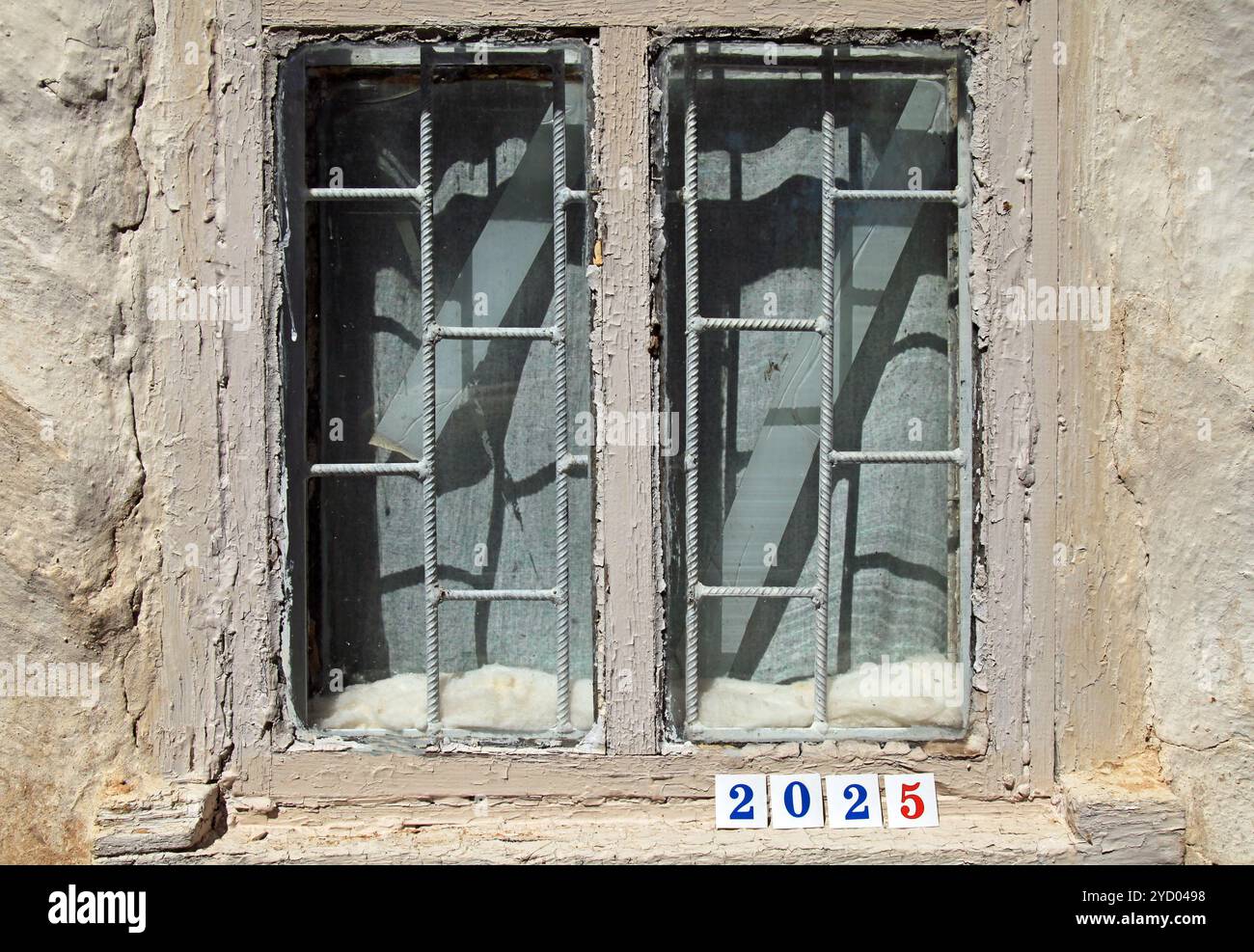Numbers of 2025 year. Paper square numbers on the old wooden window ...