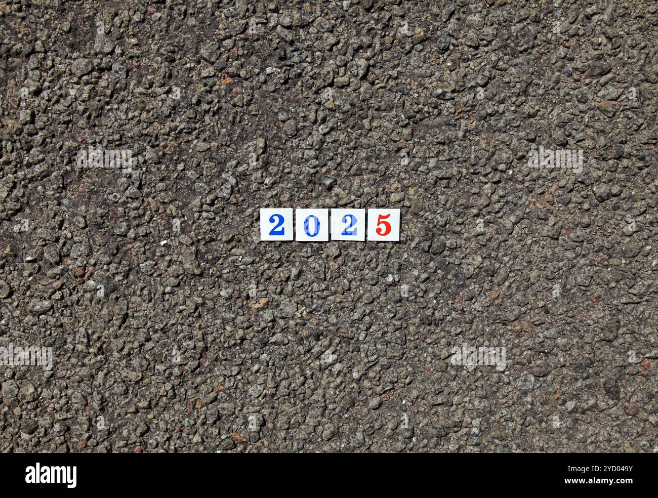 Numbers of 2025 year. Paper square numbers on the stone road background ...