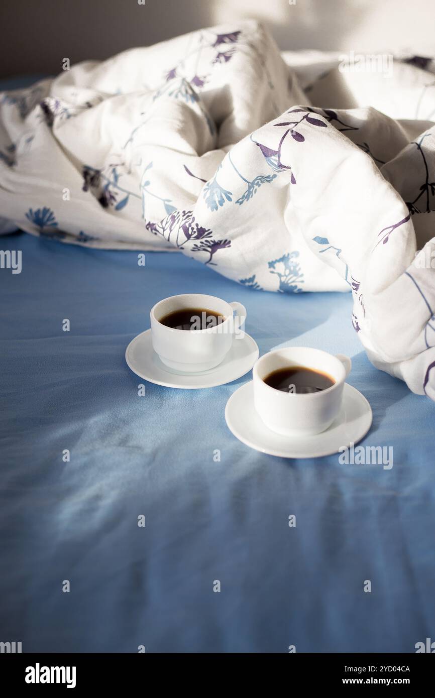 Two cups of coffee in bed, sunlight Stock Photo - Alamy