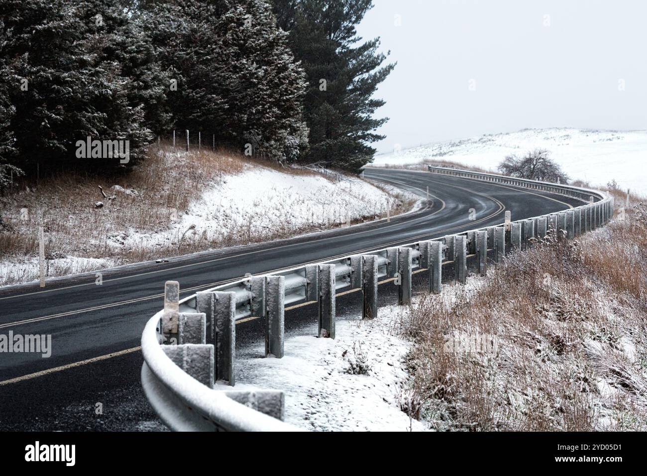 Curving road through snow covered hills Stock Photo - Alamy