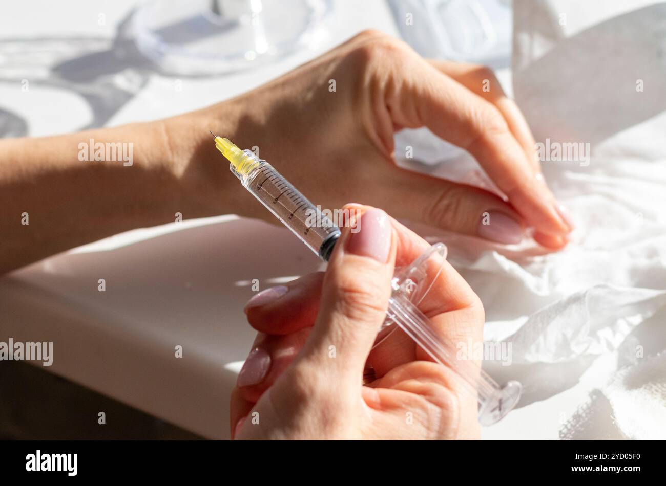 Woman performing mesotherapy, bio revitalization procedure, injecting ...