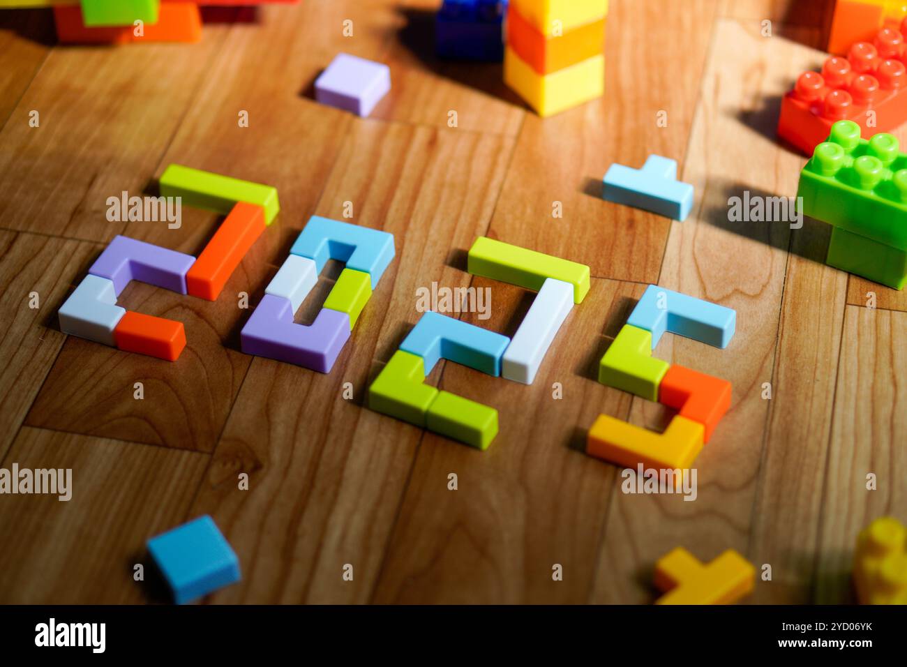 colorful interlocking puzzle pieces arranged on a wooden surface to ...