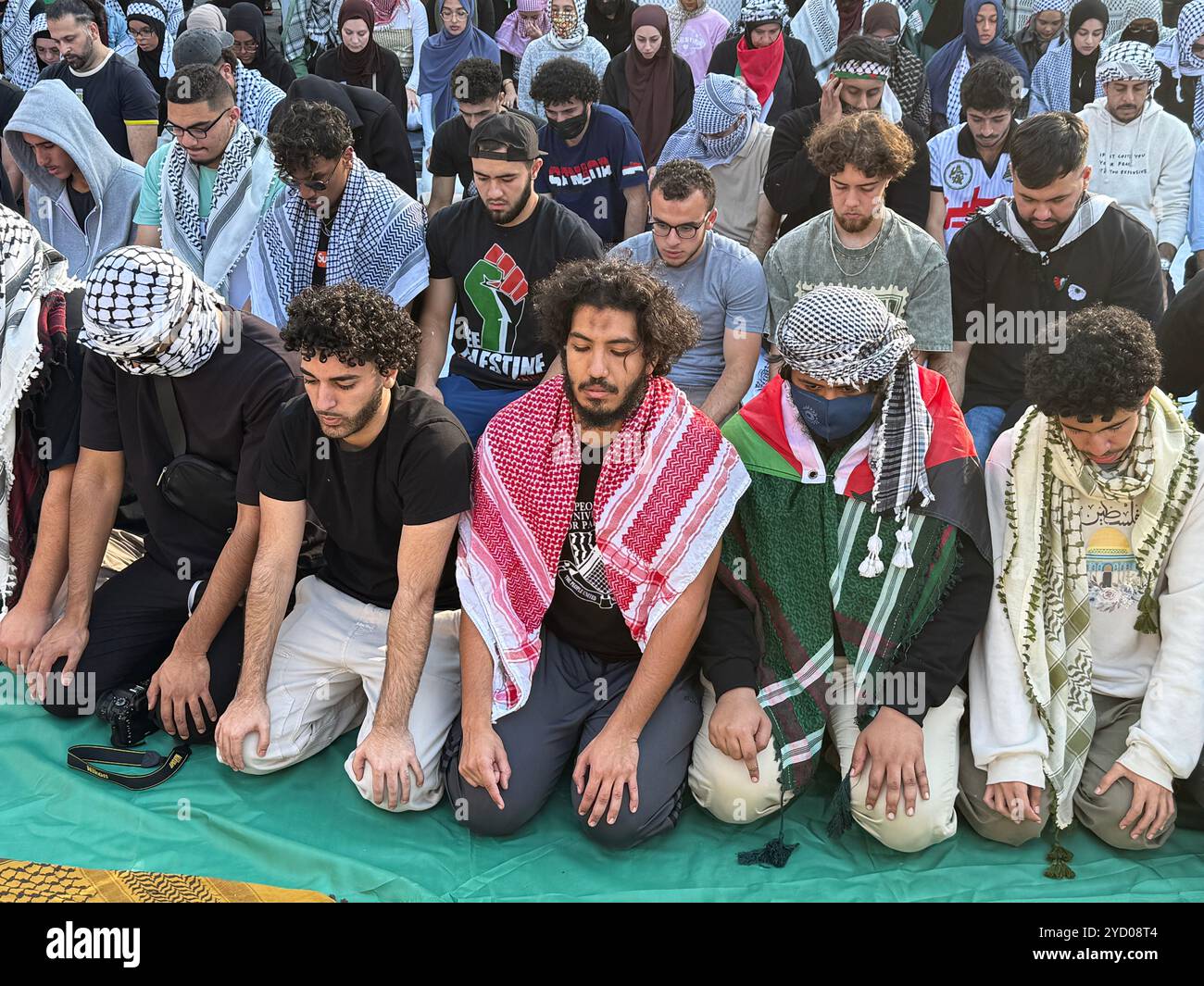 Muslim and other demonstrators pray together for the Palestinian people ...