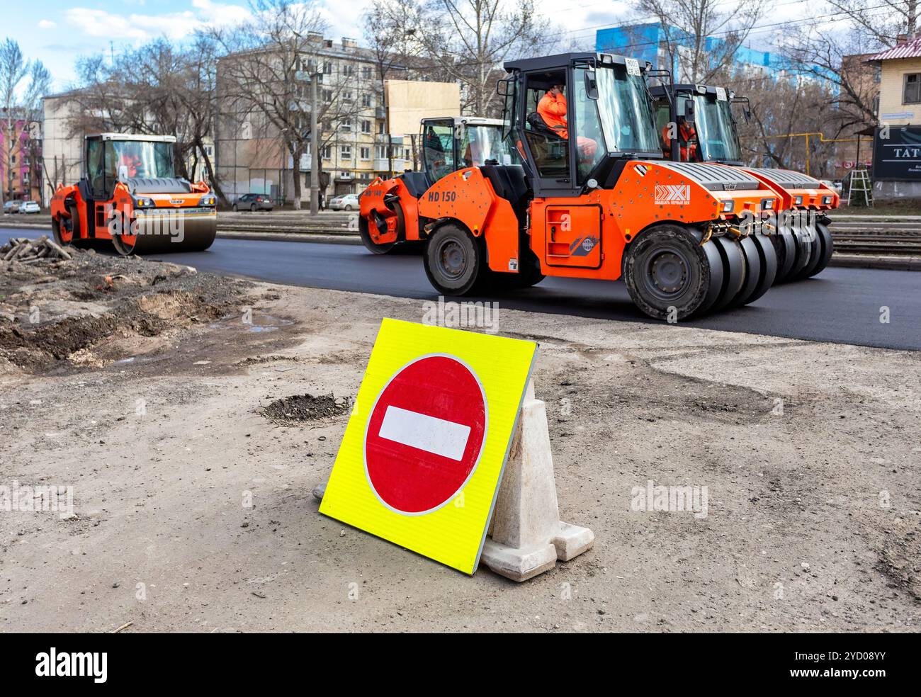 Road sign Stop against the background of laying the asphalt on a city ...