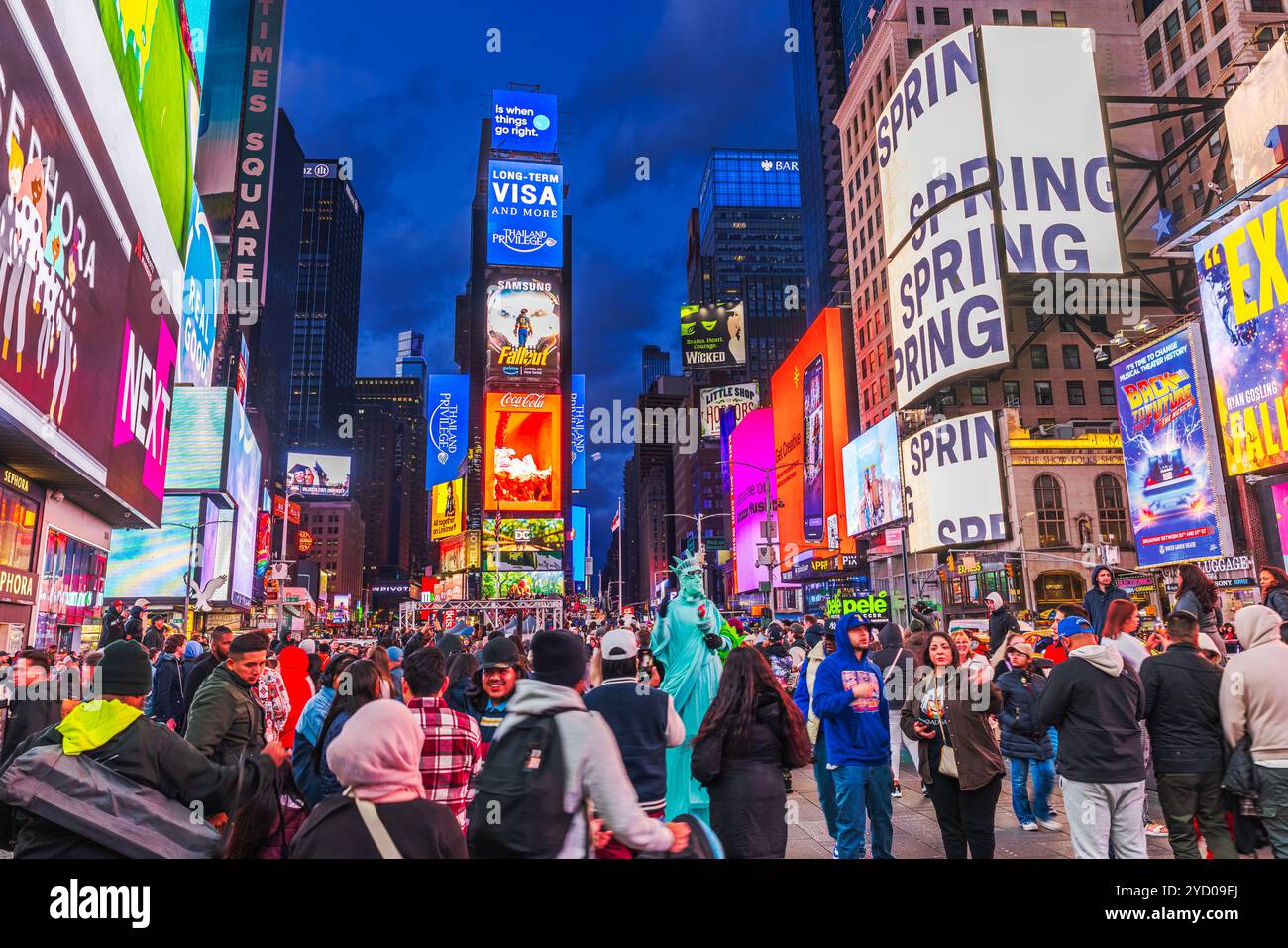 Crowded scene at Times Square in New York City, filled with tourists ...