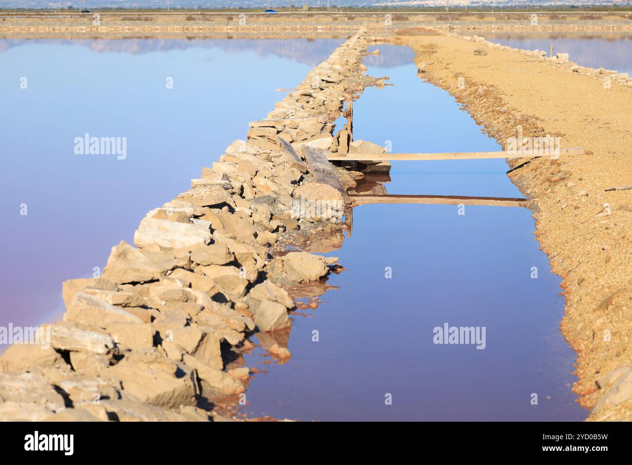 Retaining dikes in the pink lagoon of the Saltworks of the natural park ...