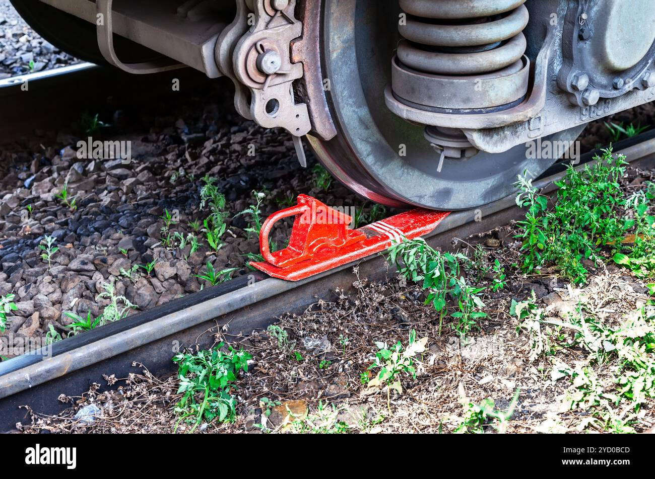Freight car is secured with red brake shoe on the railway station Stock ...