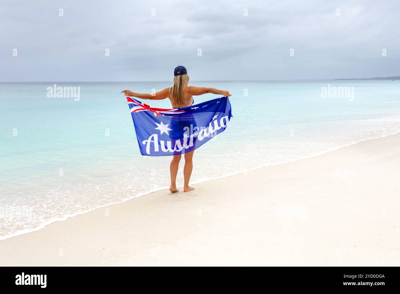 Australia pride. Woman walking along a pristine idyllic white sandy ...