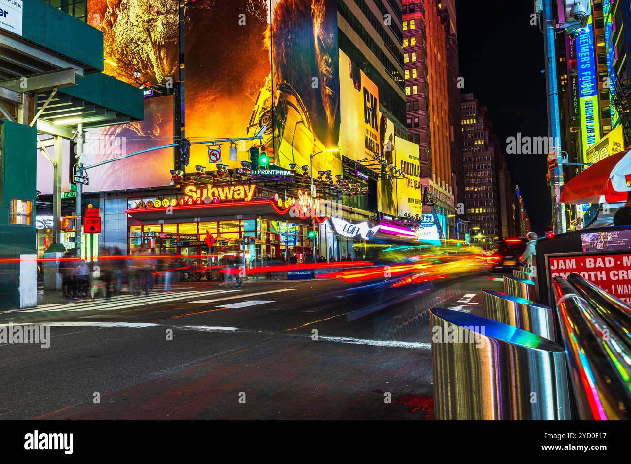 Times Square at night with subway entrance, neon lights, and bright ...