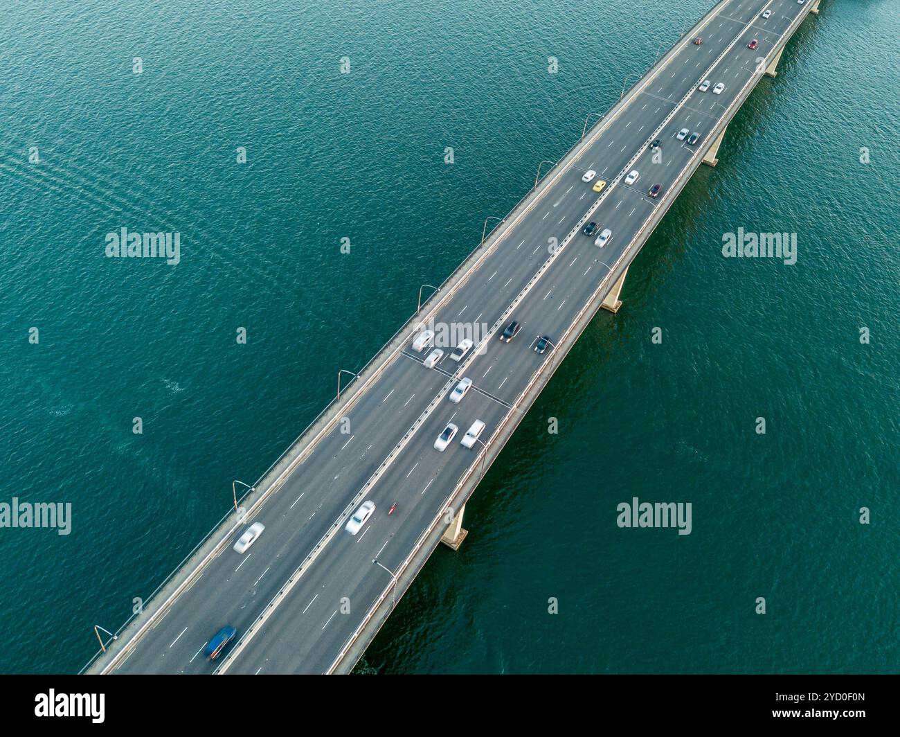 Vehicles on bridge over water Stock Photo - Alamy