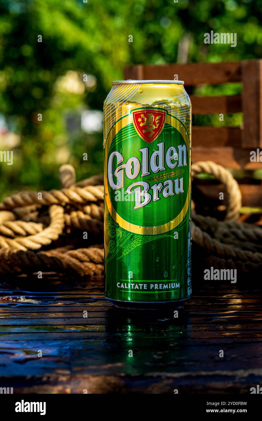 Golden Brau beer can - condensation water droplets, outdoors background ...