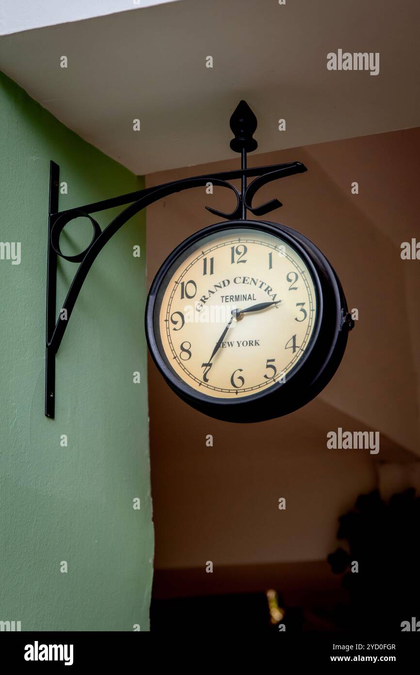 Large analog public clock with white dial and big numbers hanging from ...