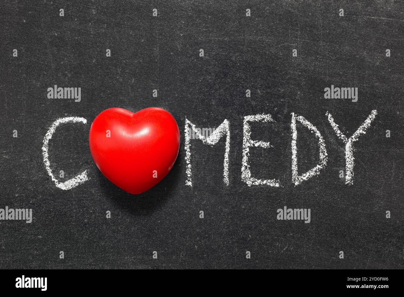 comedy word handwritten on blackboard with heart symbol instead of O ...