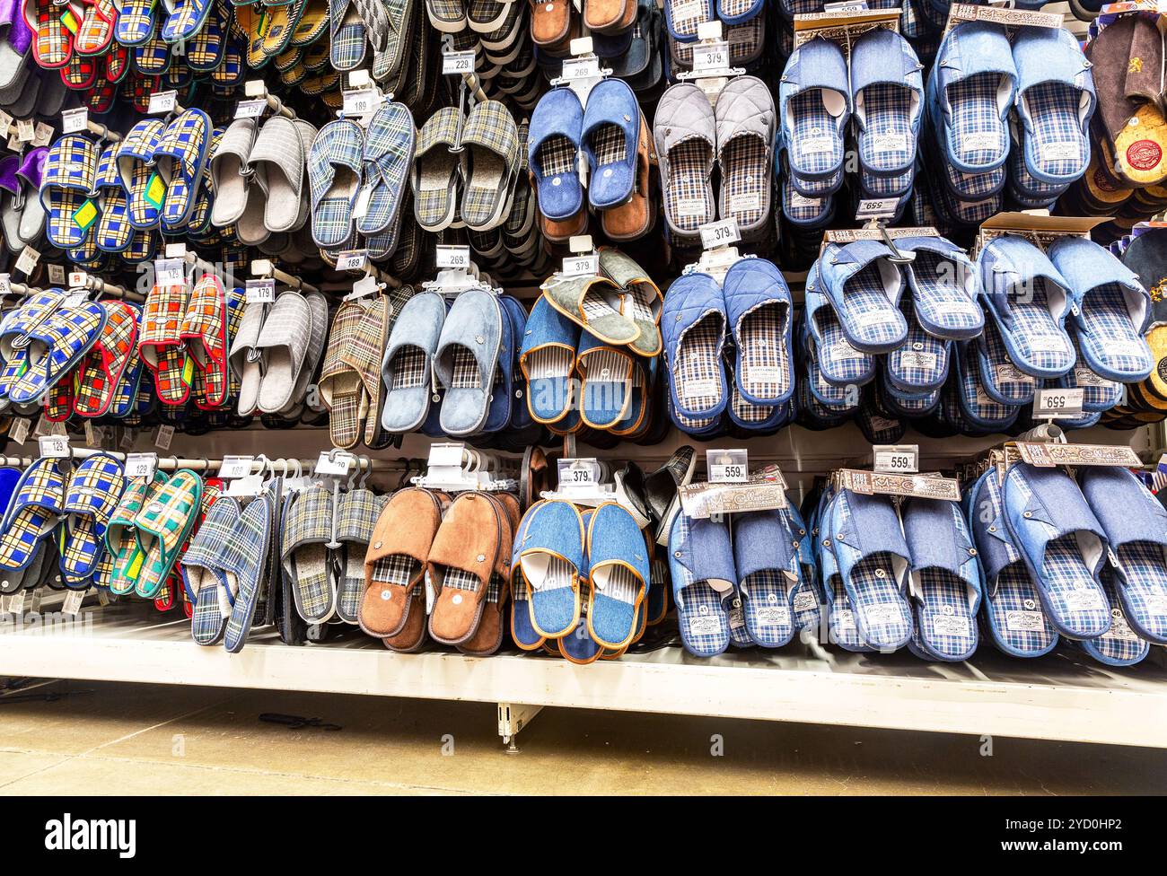 Different slippers selling at the showcase Stock Photo - Alamy