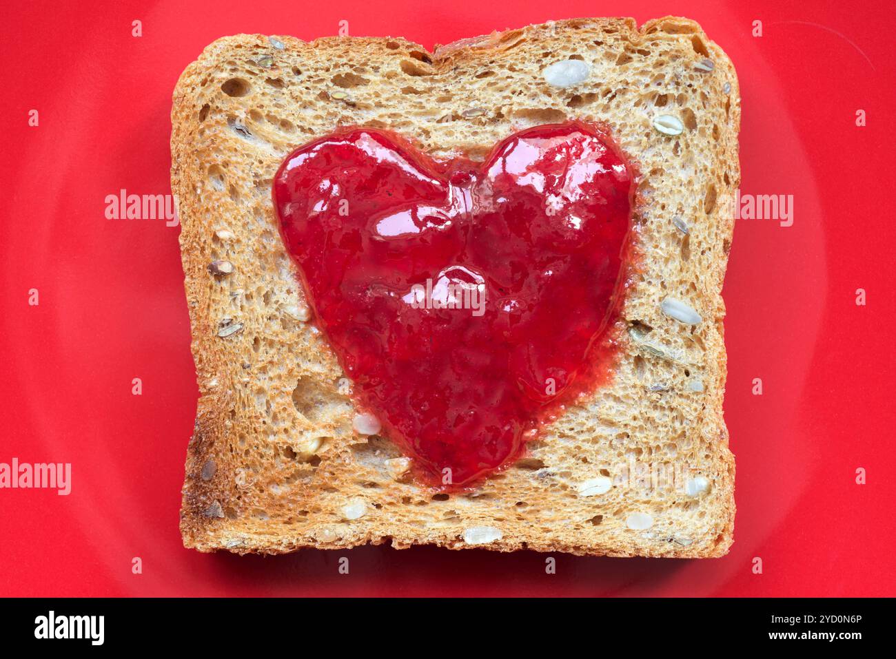 fried square toast with red jam heart on it Stock Photo - Alamy
