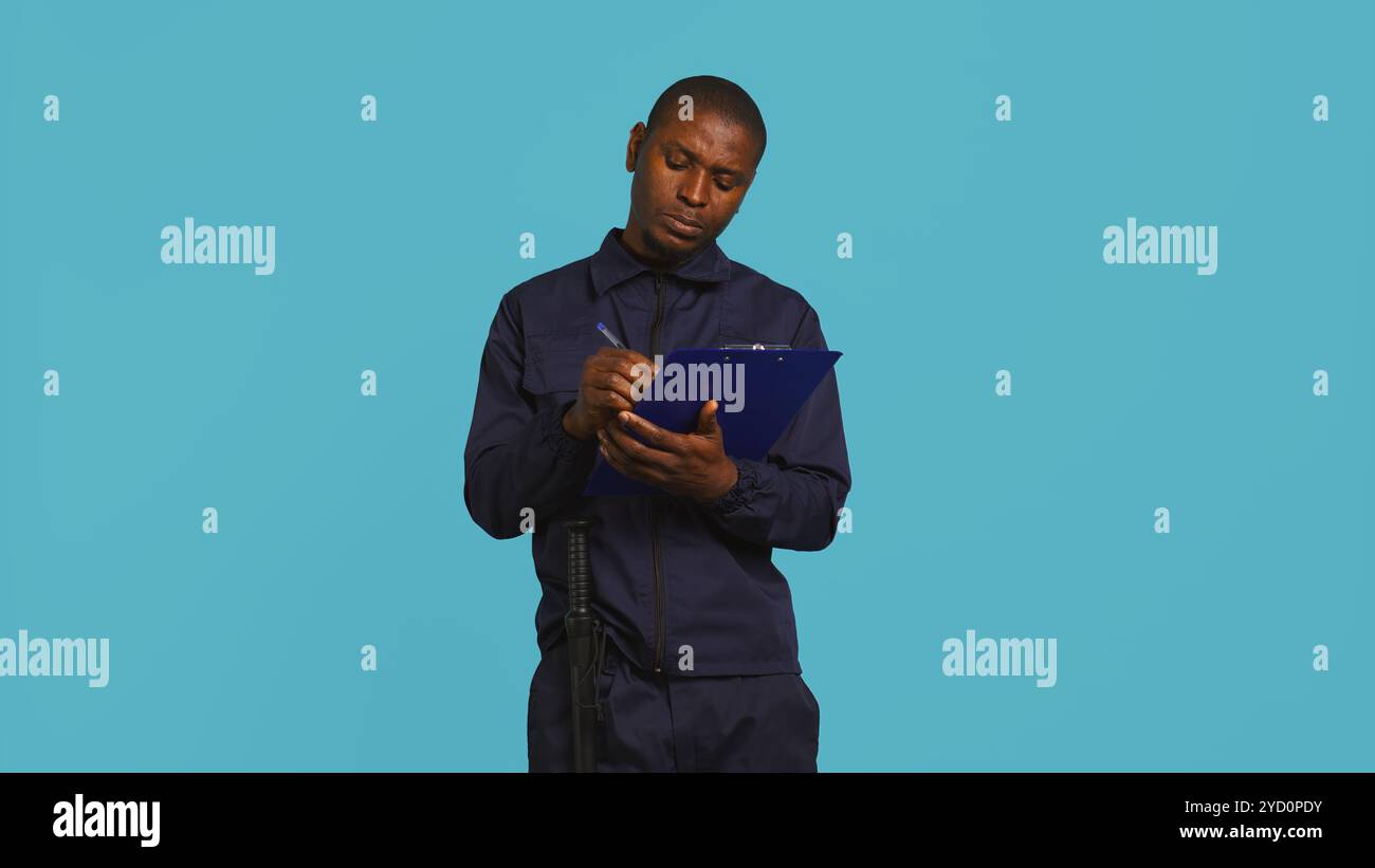 Security guard holding clipboard, taking notes, receiving orders during ...