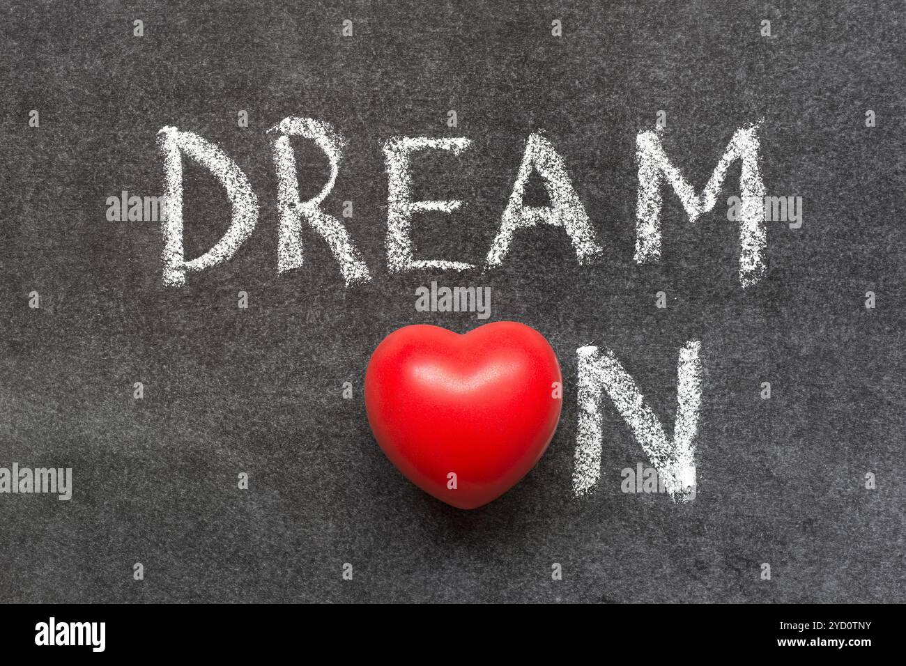 dream on phrase handwritten on blackboard with heart symbol instead of ...
