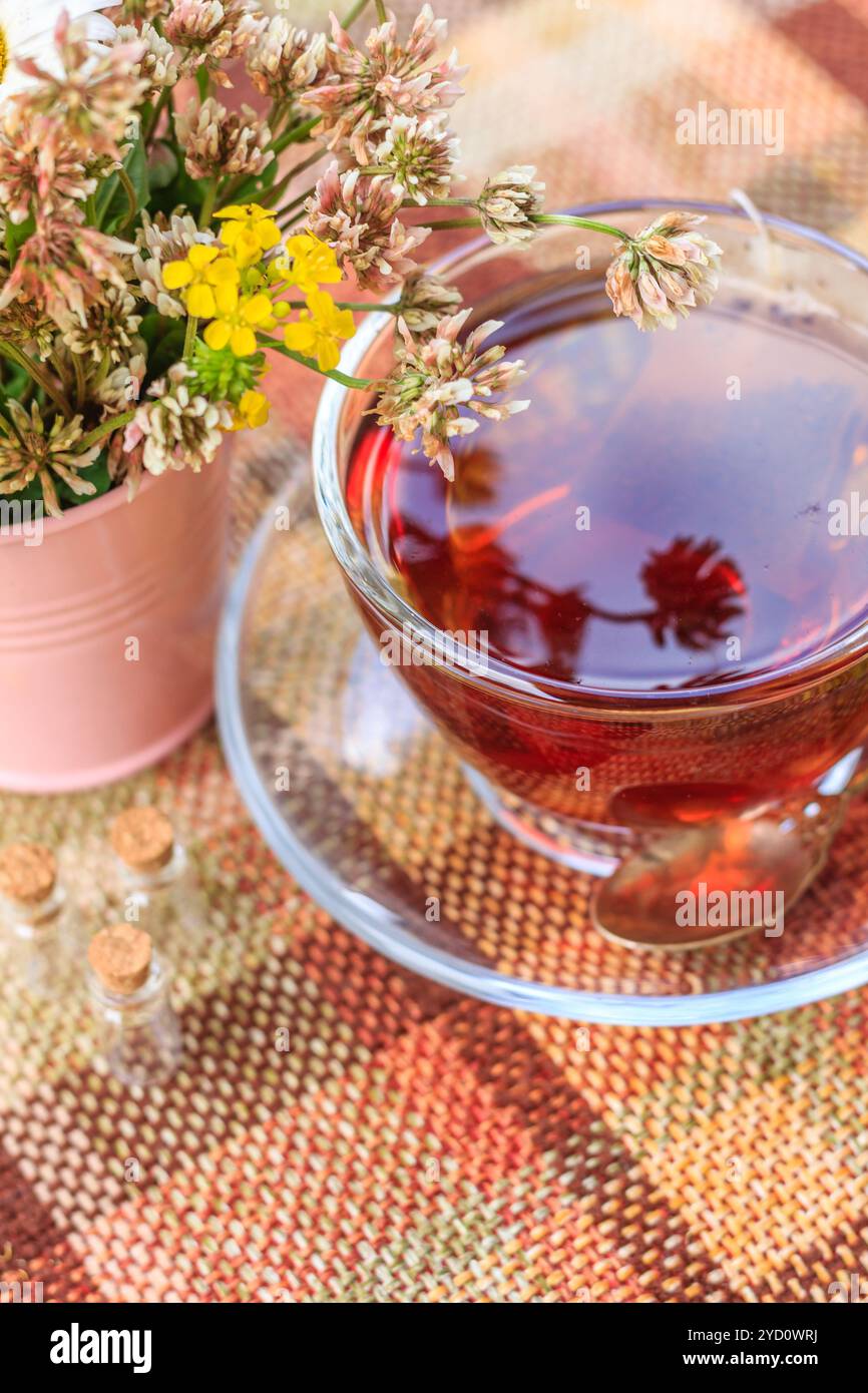 Summer tea with a book on the terrace. Summer tea with a bouquet of ...