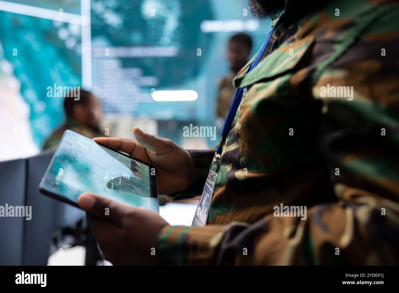 High tech military office with soldiers analyzing real time data ...