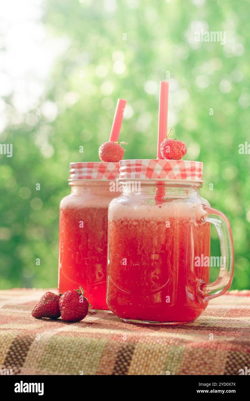 Homemade strawberry lemonade in glasses. Summer cold refreshing drink. Drink in nature ...