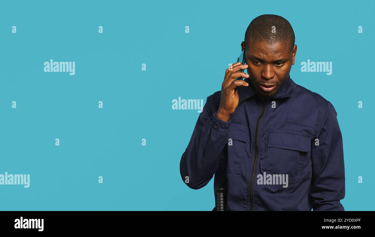 Security guard using smartphone, taking break during protection job ...