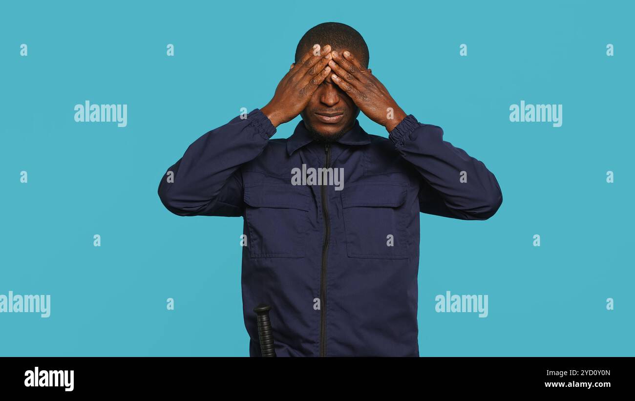 Clueless security guard shrugging shoulders, unable to answer people ...