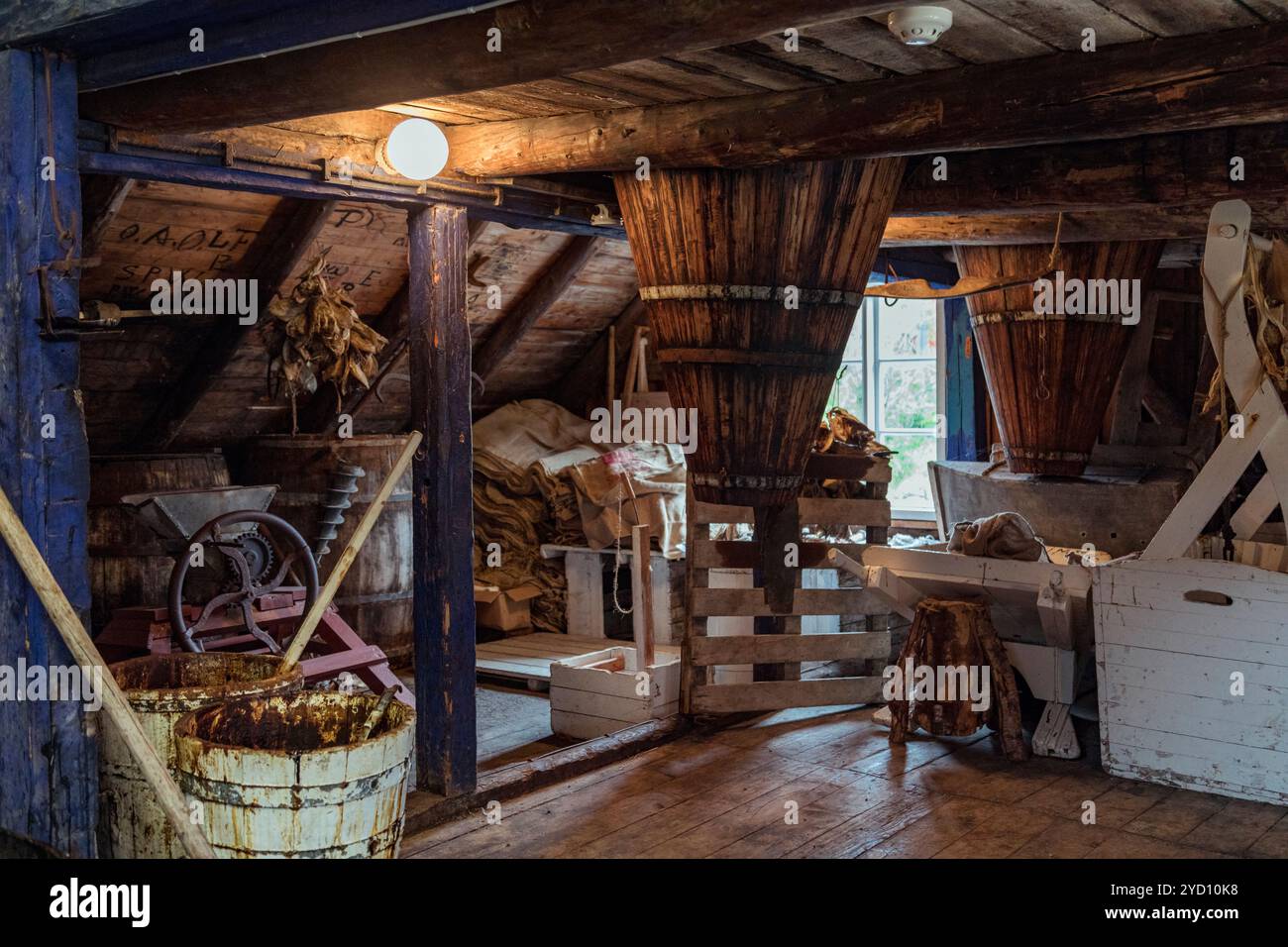 A cozy attic room in a traditional log cabin showcases fishing gear ...