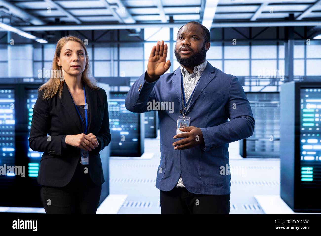 Coworkers in data center checking rigs and hardware, doing checkup with AR tech. IT staff ...