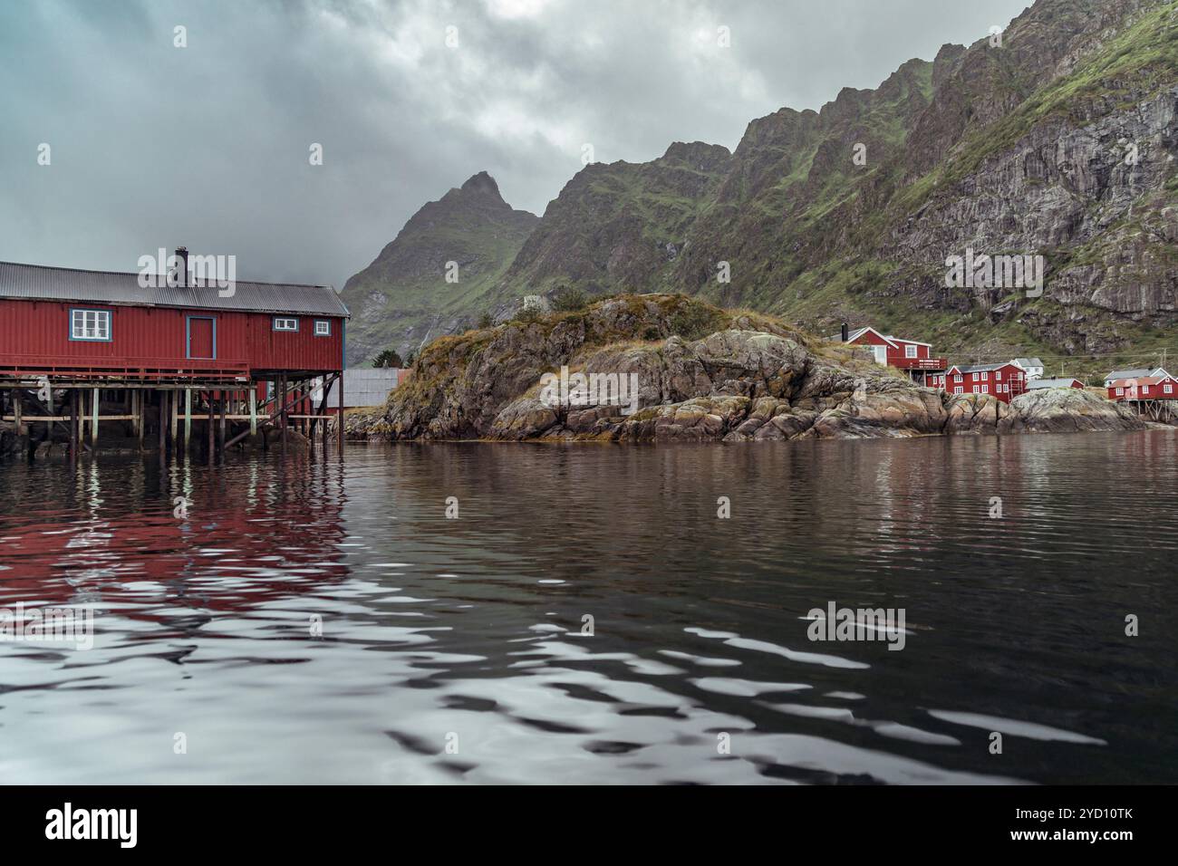 Nestled against a backdrop of majestic mountains, traditional red ...