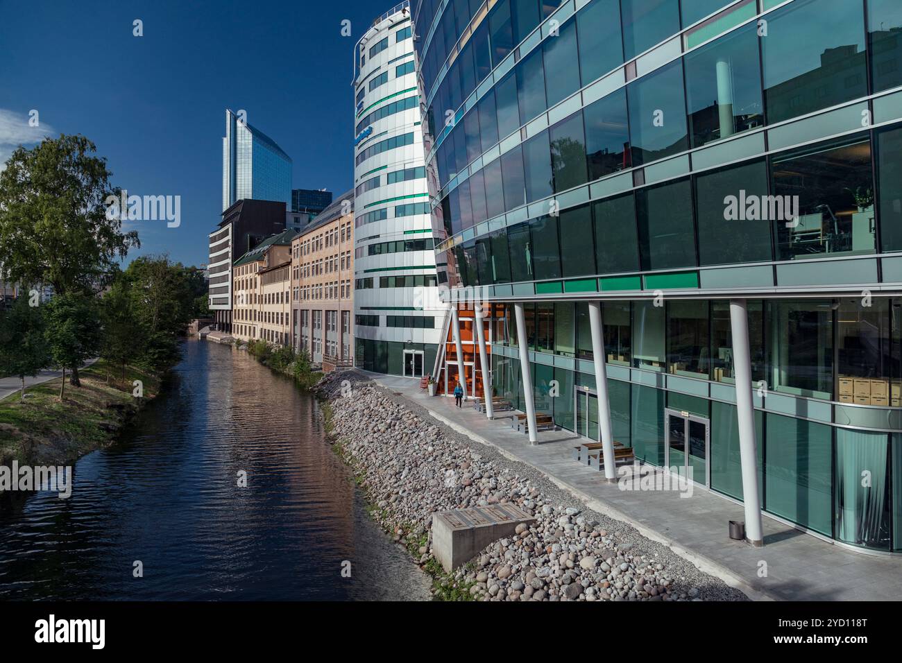 A sleek condominium complex reflects in the waterway beside it ...