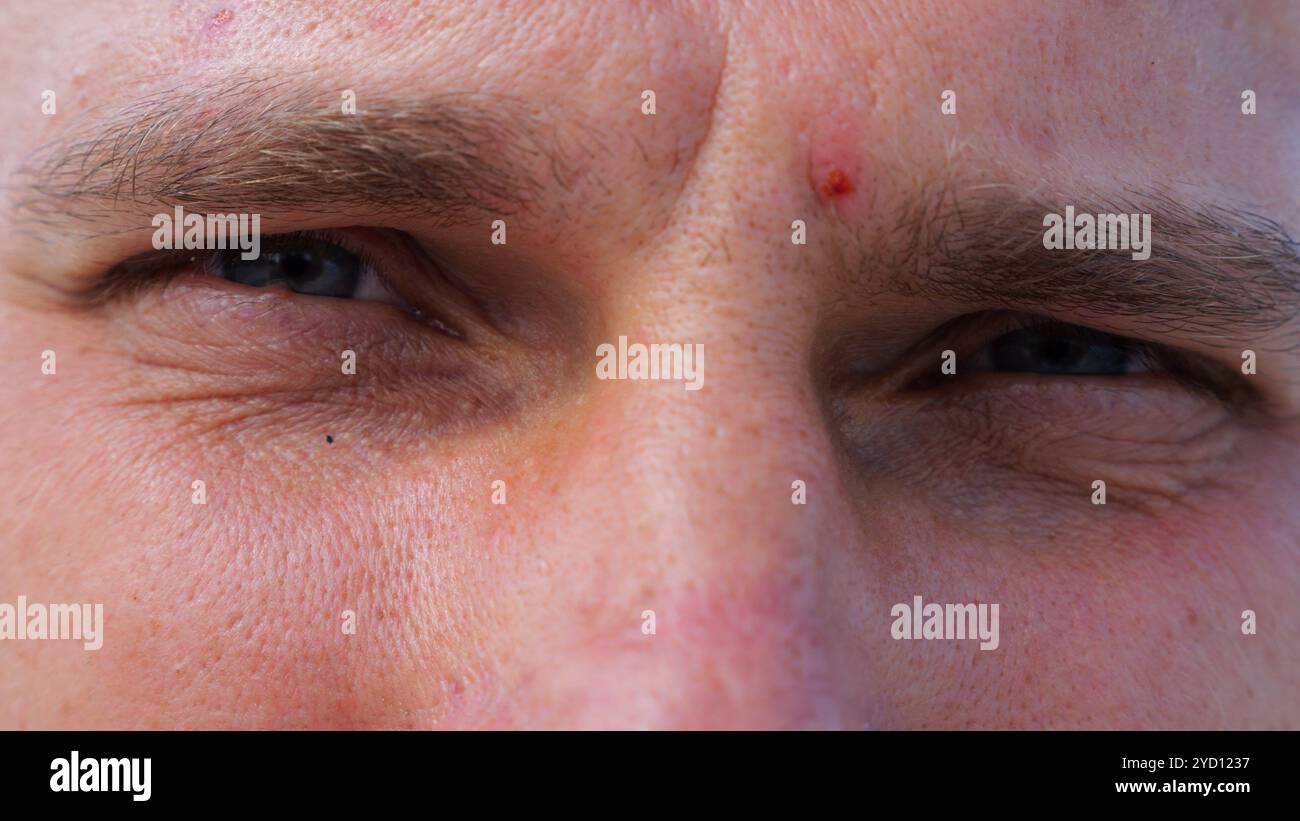 Close up to upset male face looking into camera with a disappointing ...