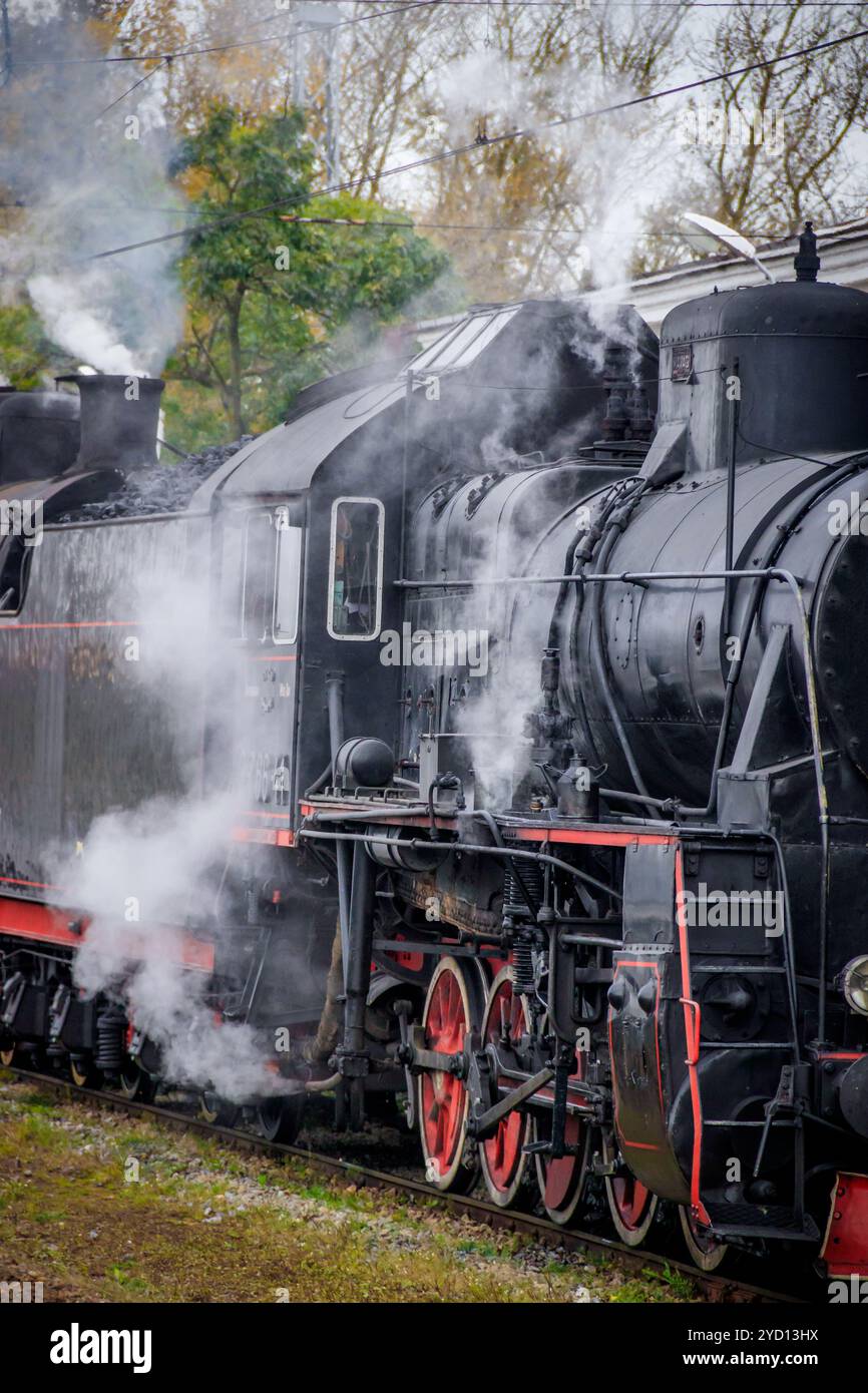 Old Russian locomotive on the railway. Old black locomotive. Smoke from ...