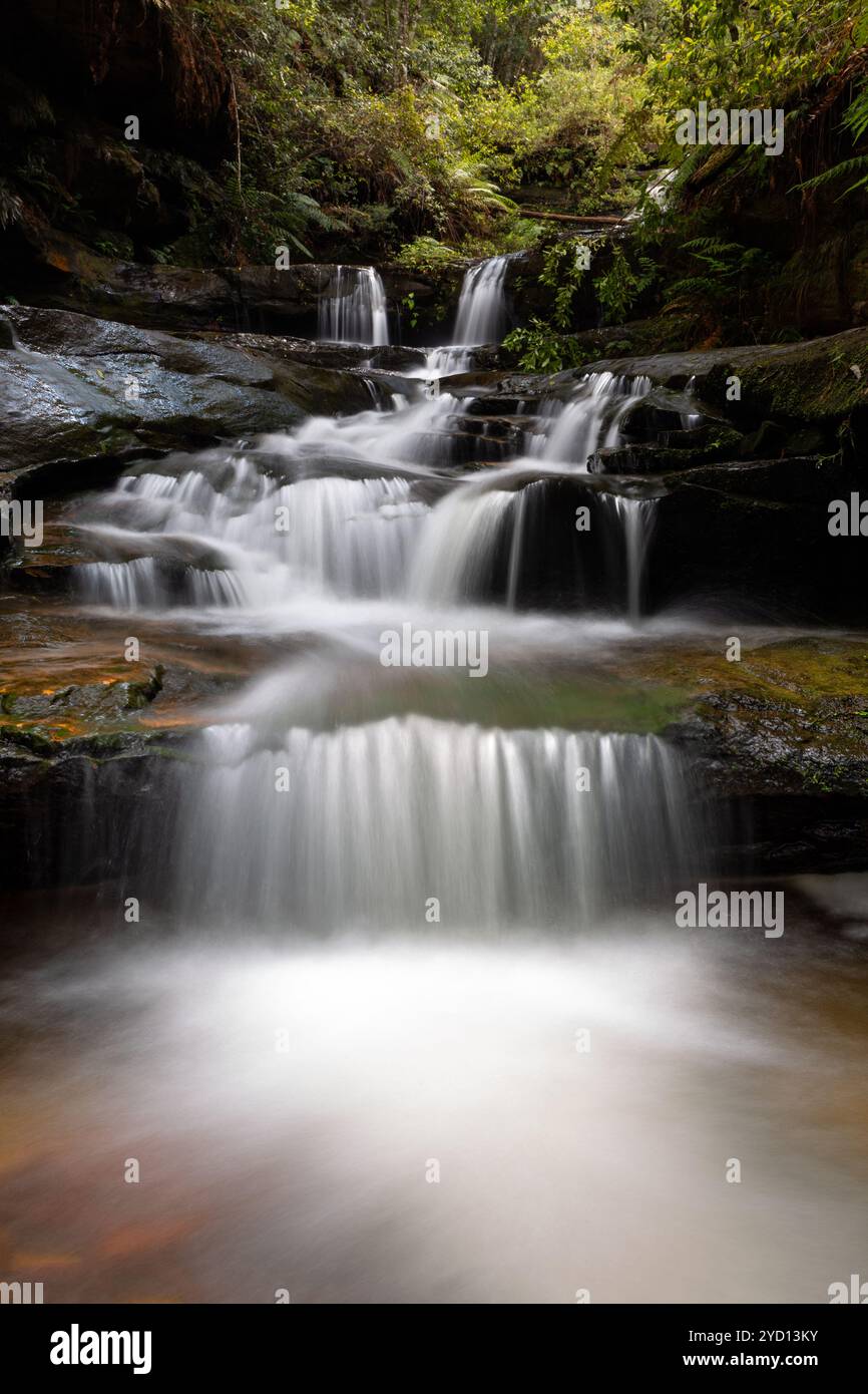 Cascading water through gully into little rock pool Stock Photo - Alamy