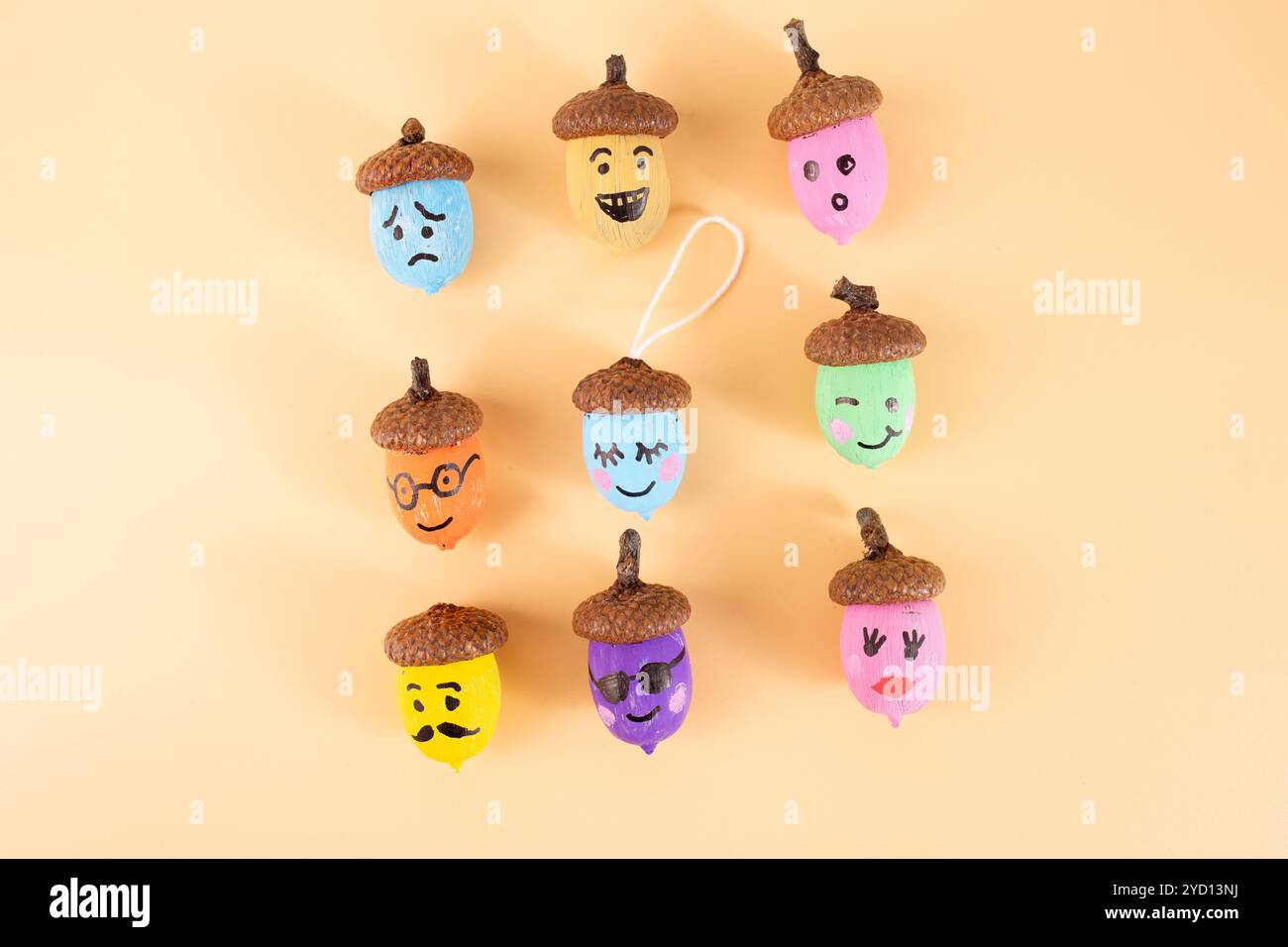 Colorful acorns with emoji faces on peach background. Autumn DIY craft ...