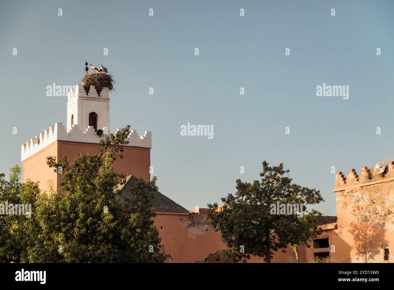 A charming chapel stands prominently with a bell tower and a stork nest ...
